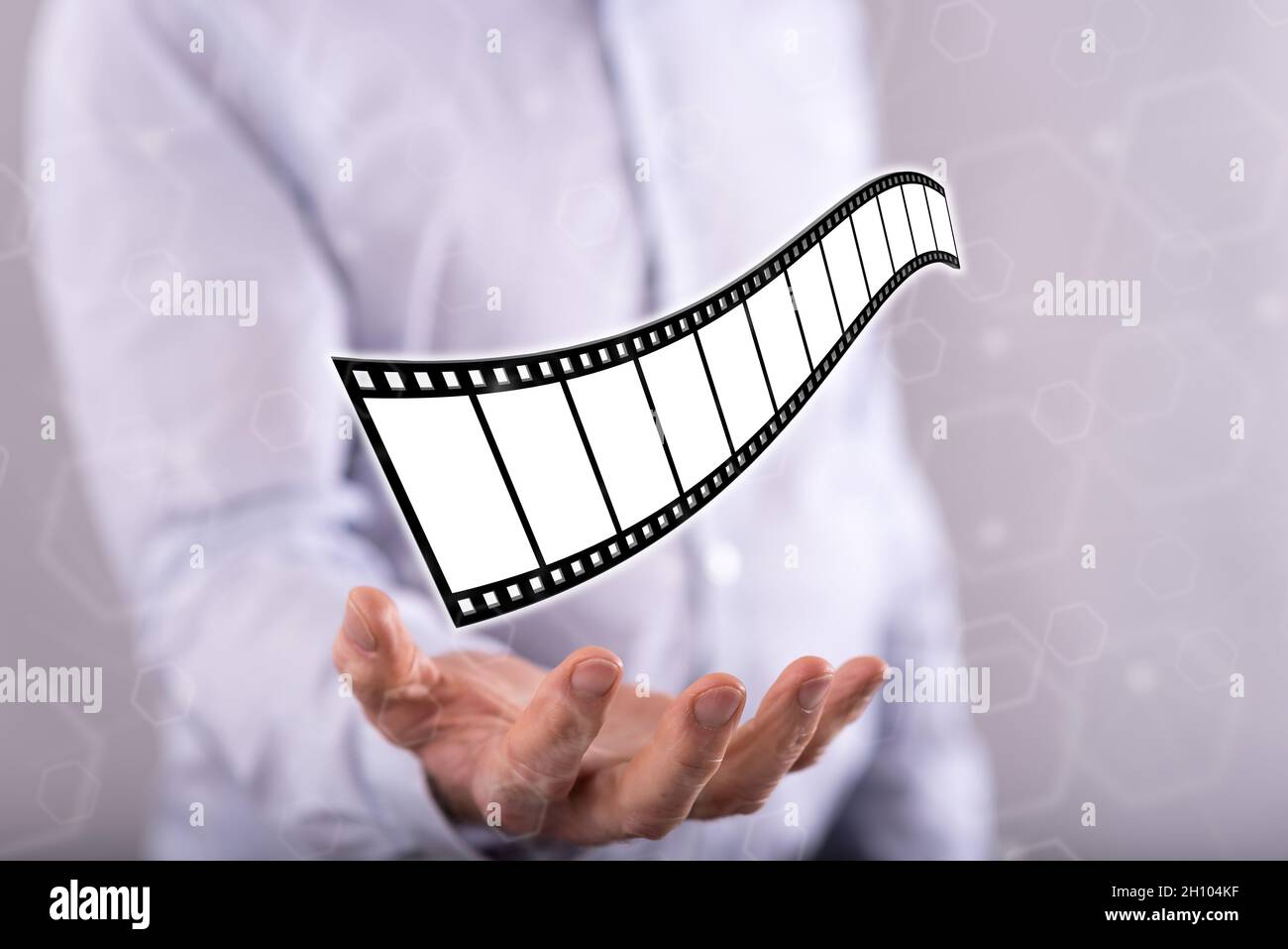 Movies, video and cinema concept above the hand of a man in background ...