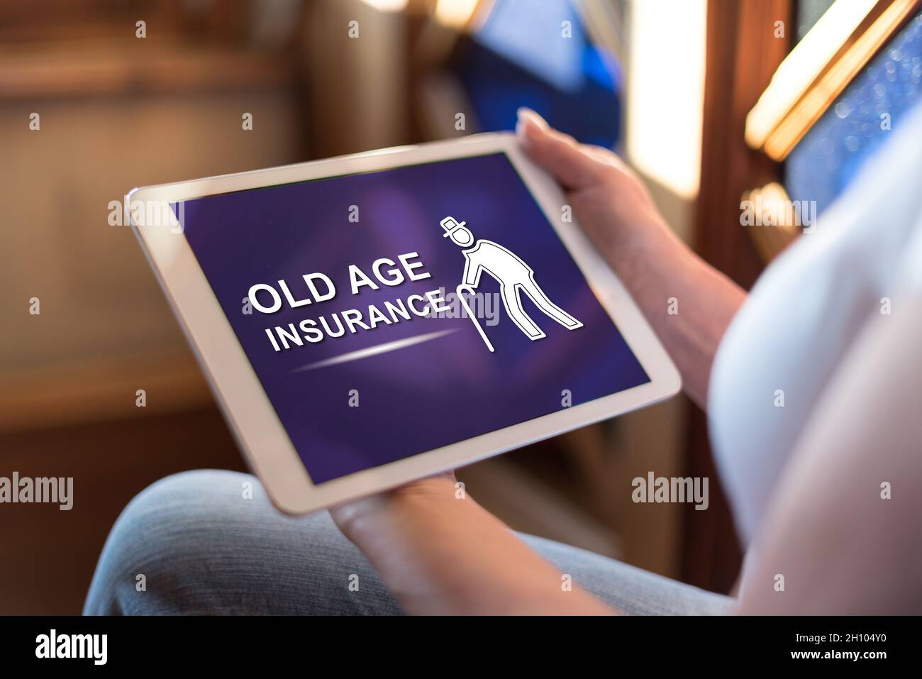 Woman holding a tablet showing old age insurance concept Stock Photo ...