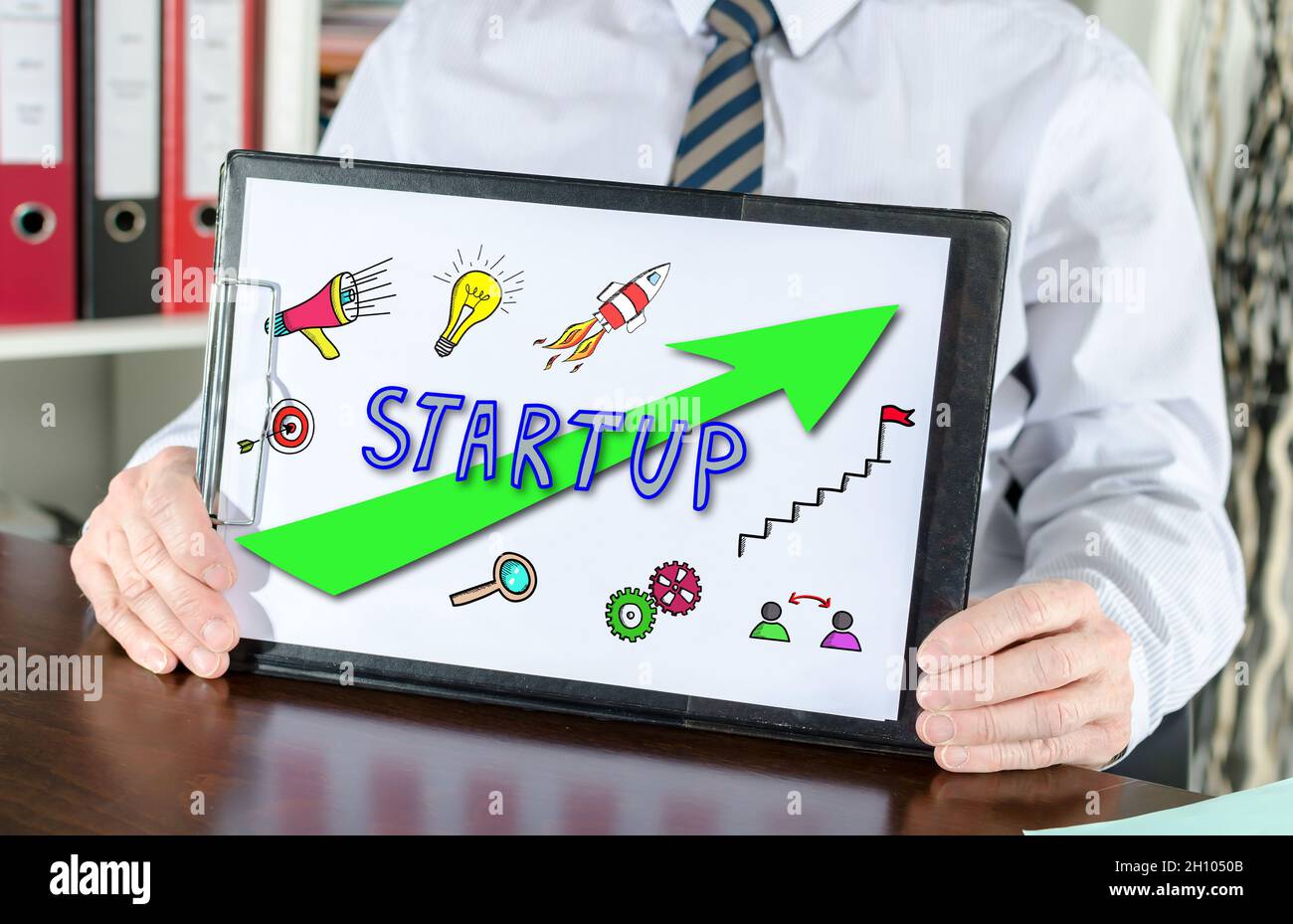 Startup concept shown by a businessman Stock Photo - Alamy