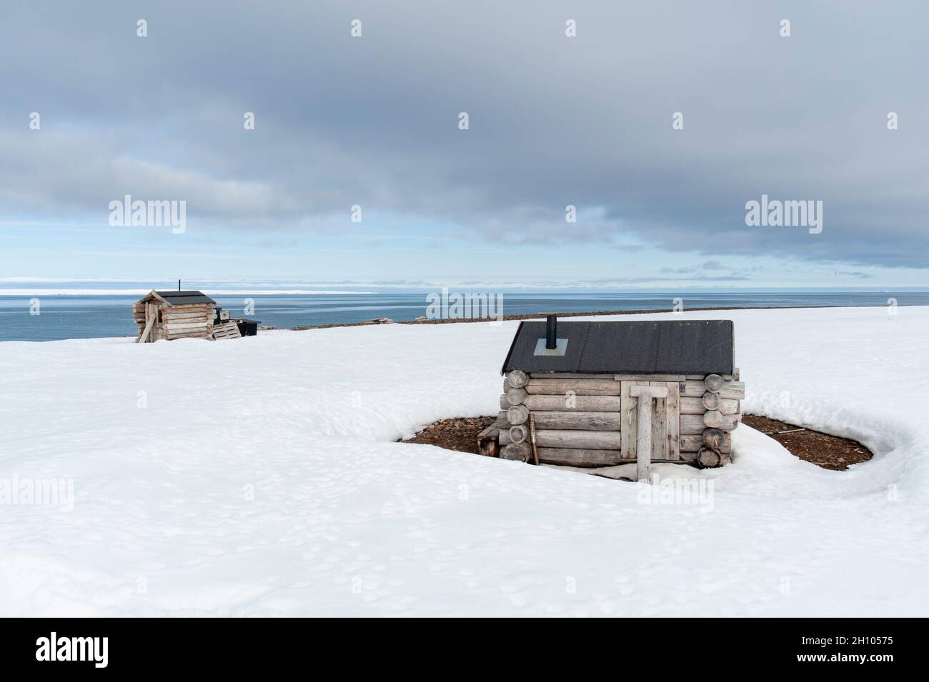 Fox hunting log cabins on the snow covered beach at Mushamna. Mushamna ...