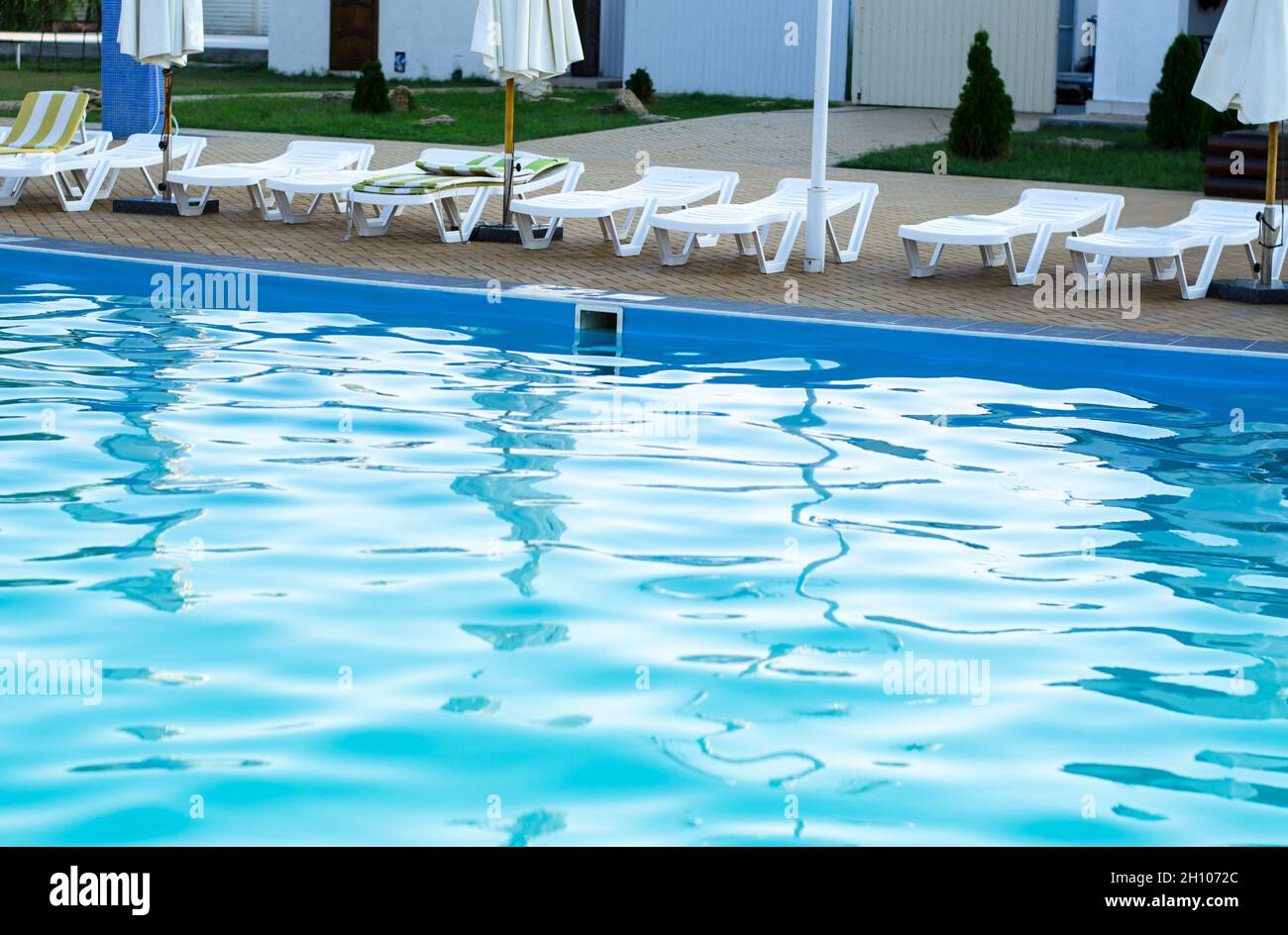Pool view and sun loungers. Summer relaxation by the pool Stock Photo ...