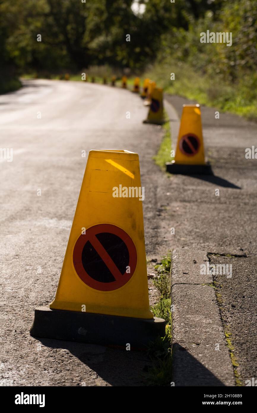 yellow uk traffic cones for no parking Stock Photo - Alamy