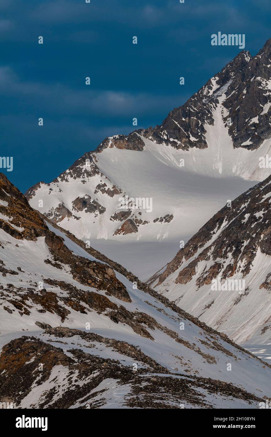 Snow streaked mountain peaks above Magdalenefjorden. Magdalenefjorden ...