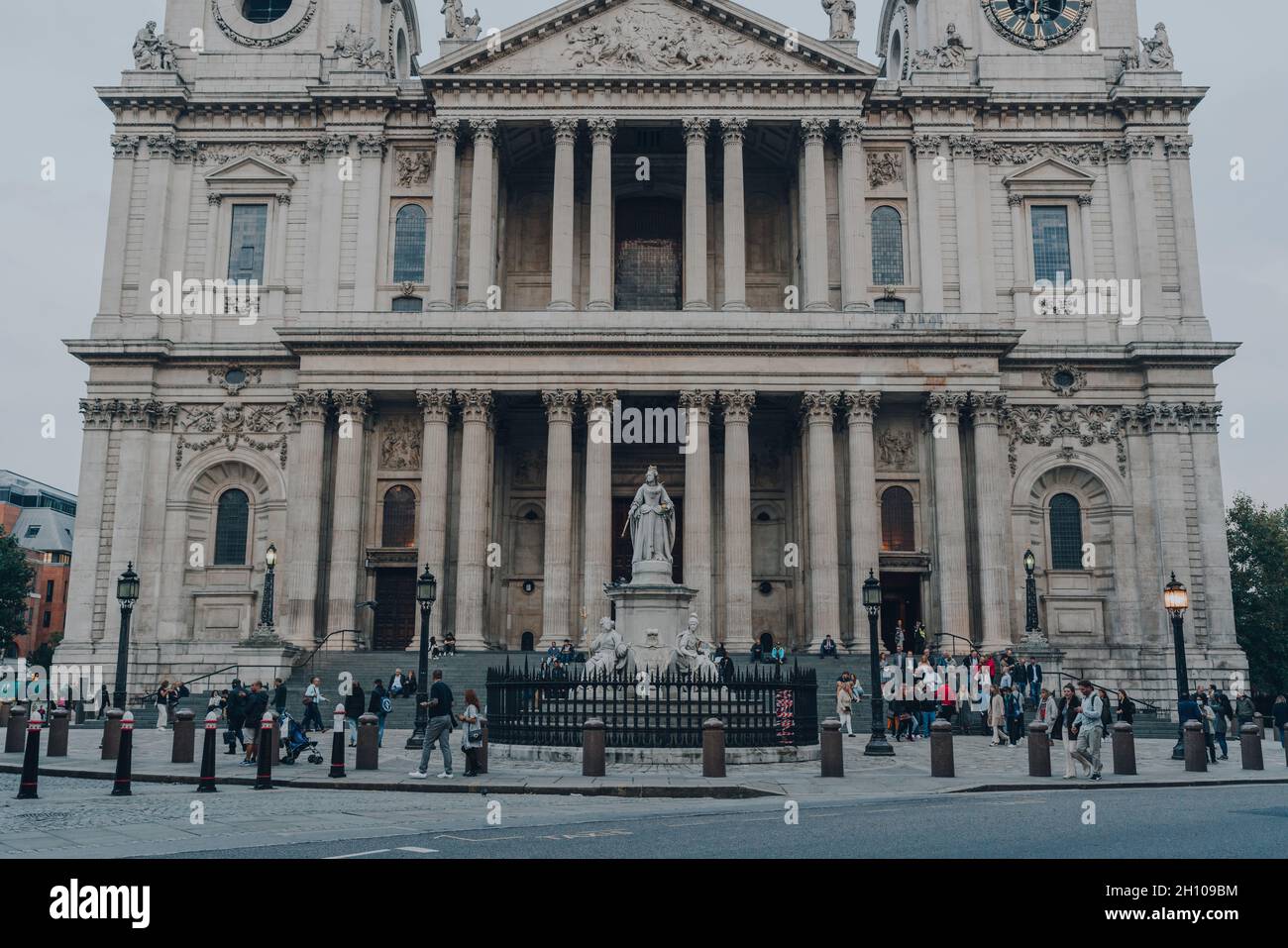 London, UK - October 09, 2021: People walking in front and sitting on ...