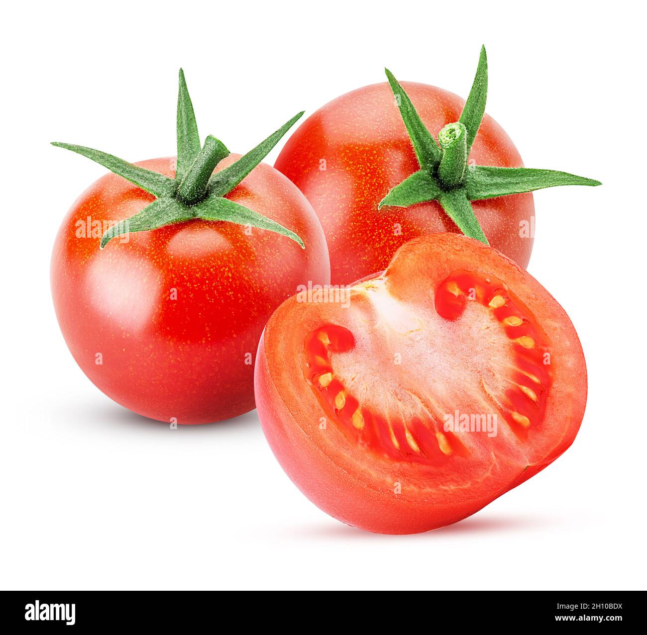 Two fresh red tomato and one cut in half with green leaves isolated on ...