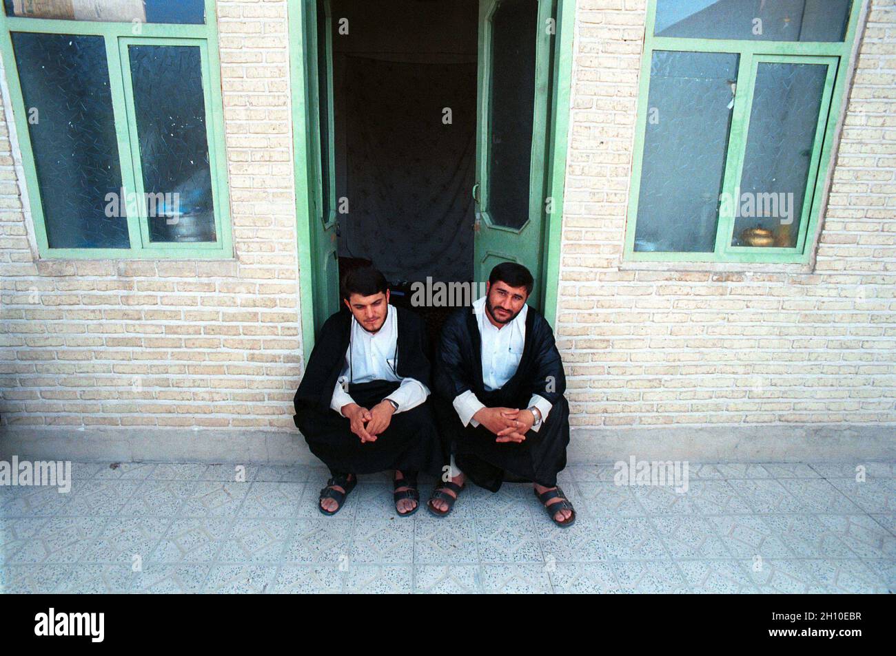 Two Iranian clergy students sitting infront of their room at Fayzieh ...