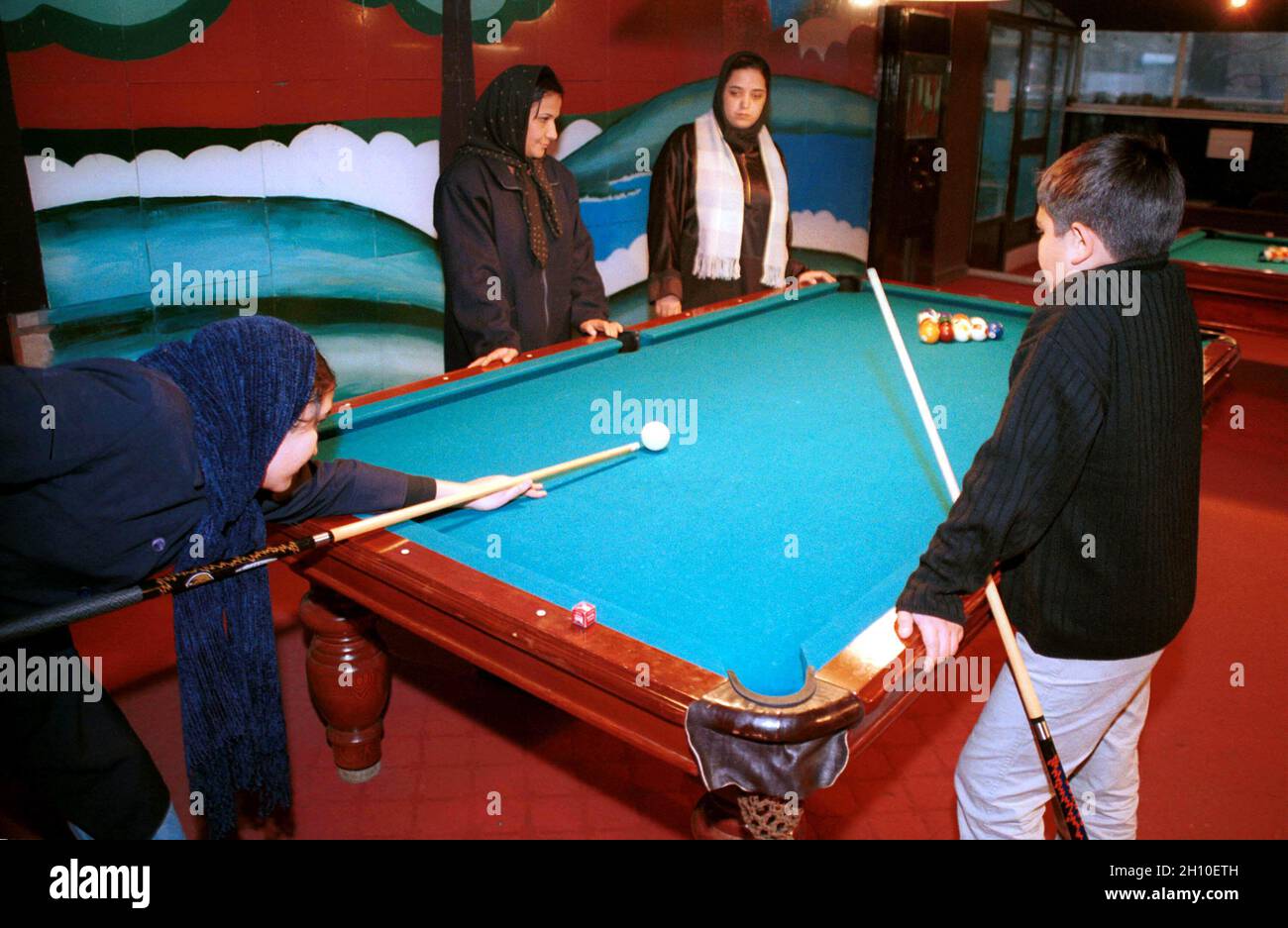 An Iranian girl playing Billiard along her family in north of Tehran ...