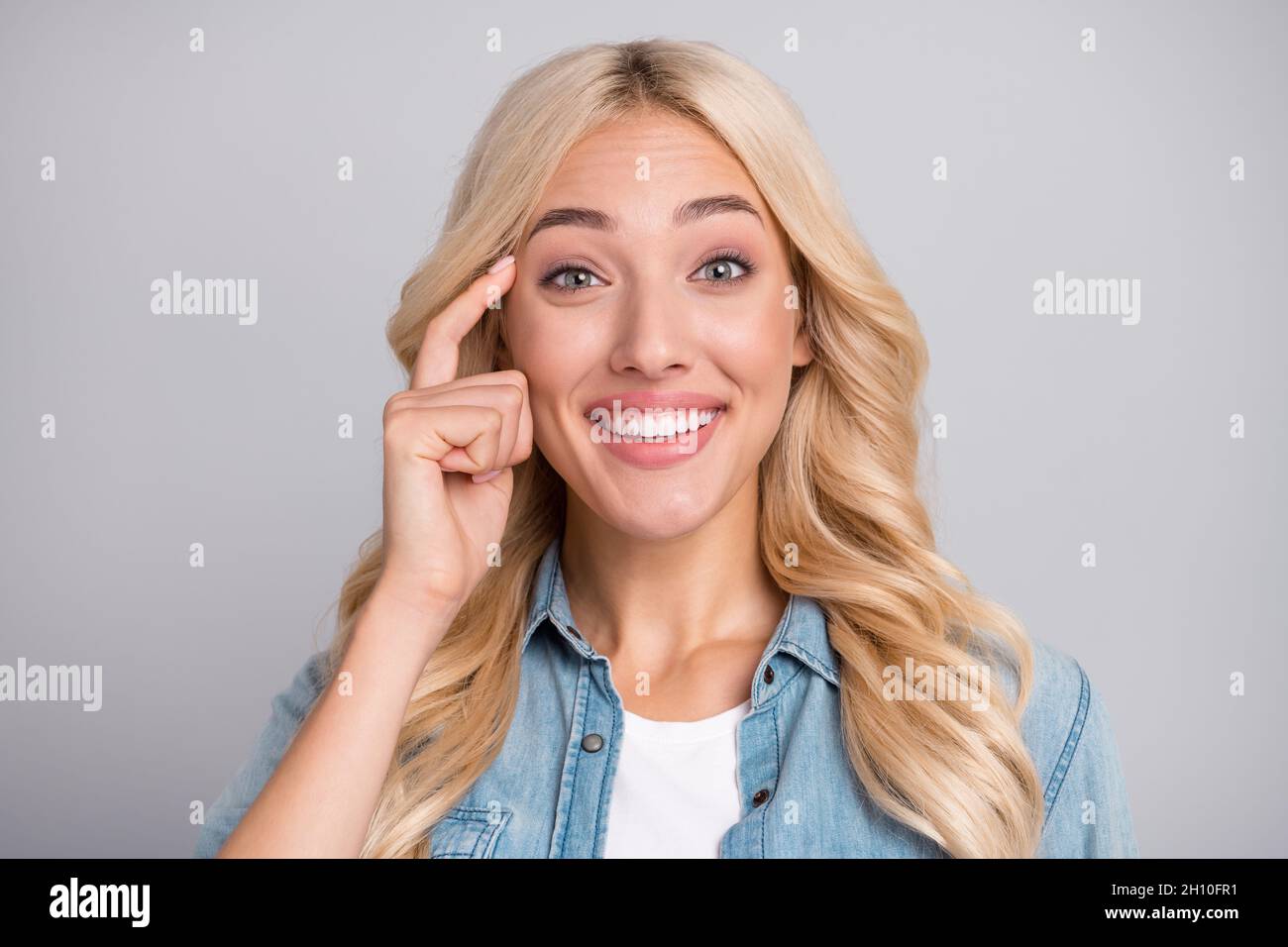 Photo of young girl happy positive smile finger touch head think forget ...
