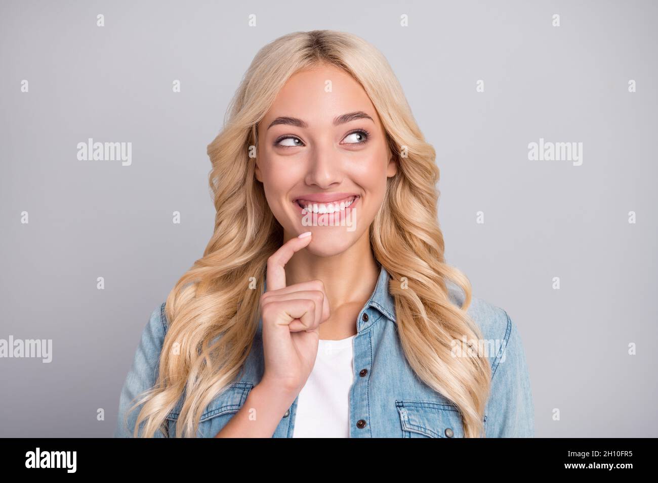 Photo of young woman happy positive smile finger touch chin curious ...