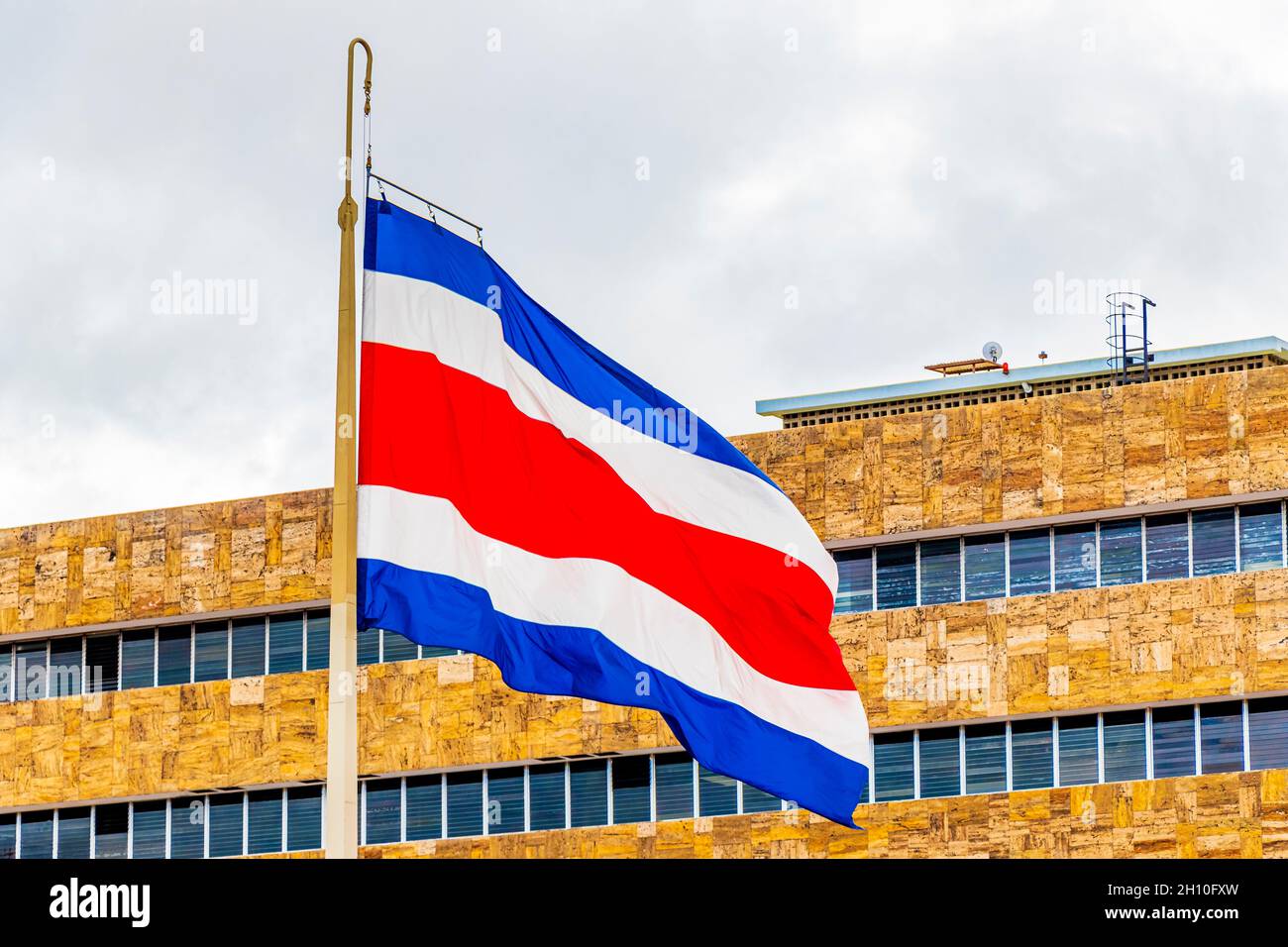 Flag of Costa Rica with old buildings behind Costa Rican flag blue ...