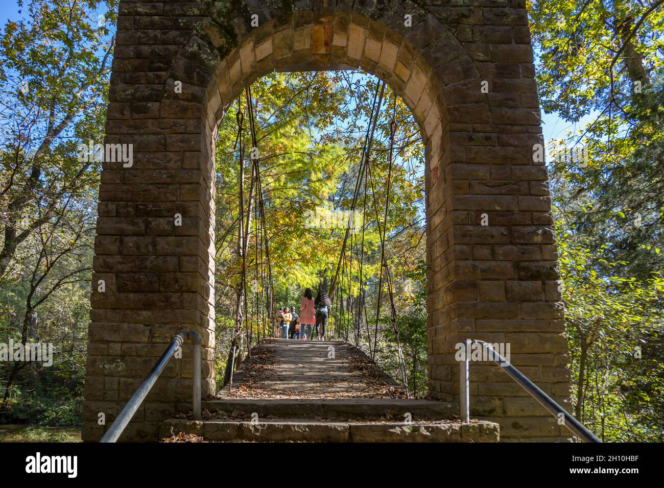 Park visitors walking across the Swinging bridge constructed in 1939 at ...