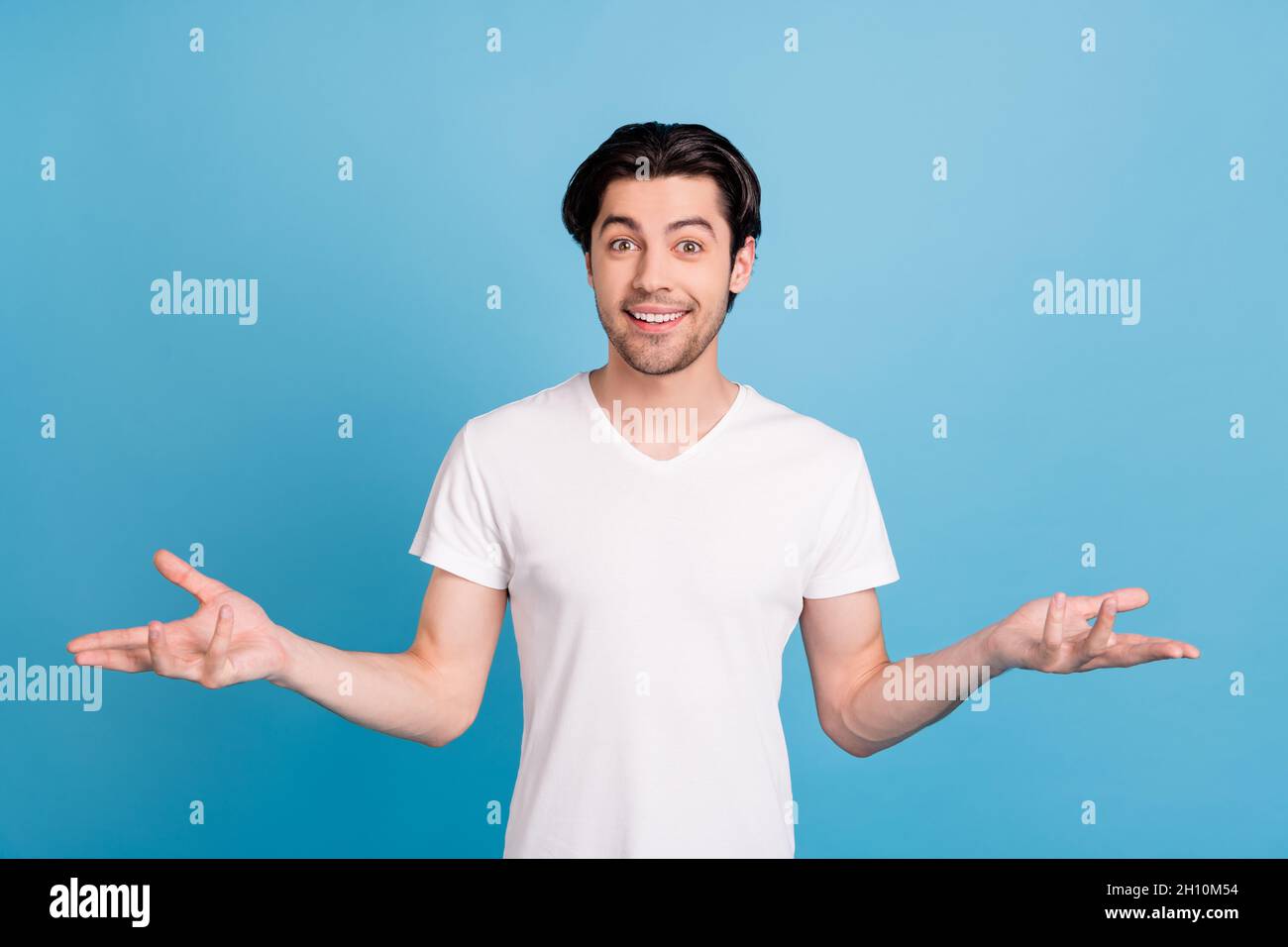 Photo of cheerful hospitable guy open hands welcome invitation wear ...