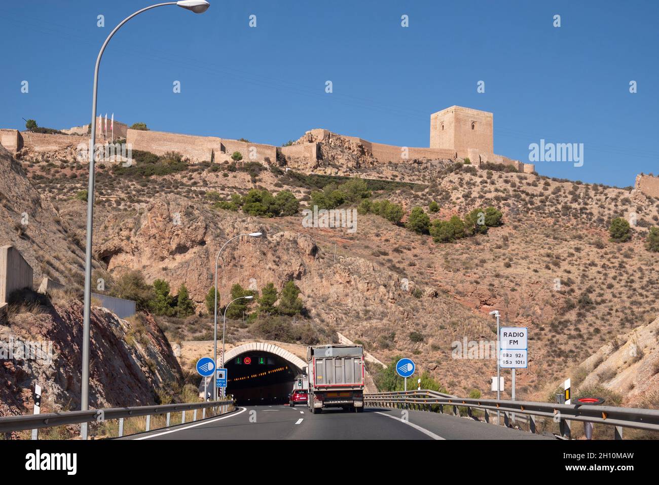 Castle of Lorca, above the A-7 road tunnel in Lorca, Region of Murcia ...