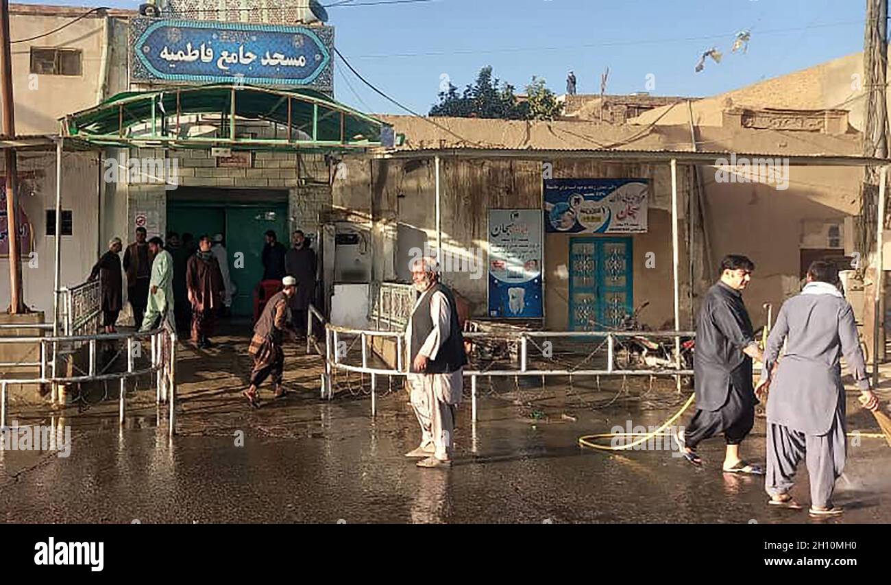 Kandahar, Afghanistan. 15th Oct, 2021. Afghan men inspect the damage ...