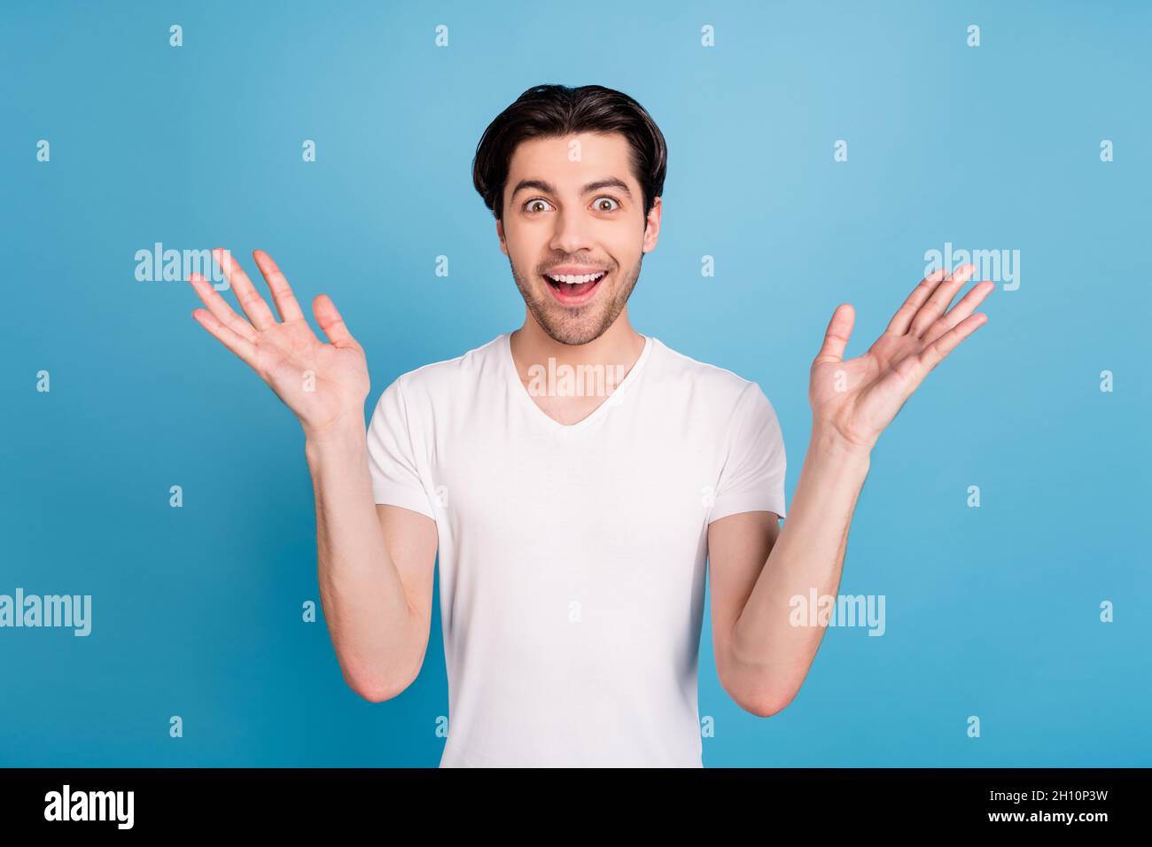 Photo of surprised amazed funky guy raise hands omg reaction wear white ...