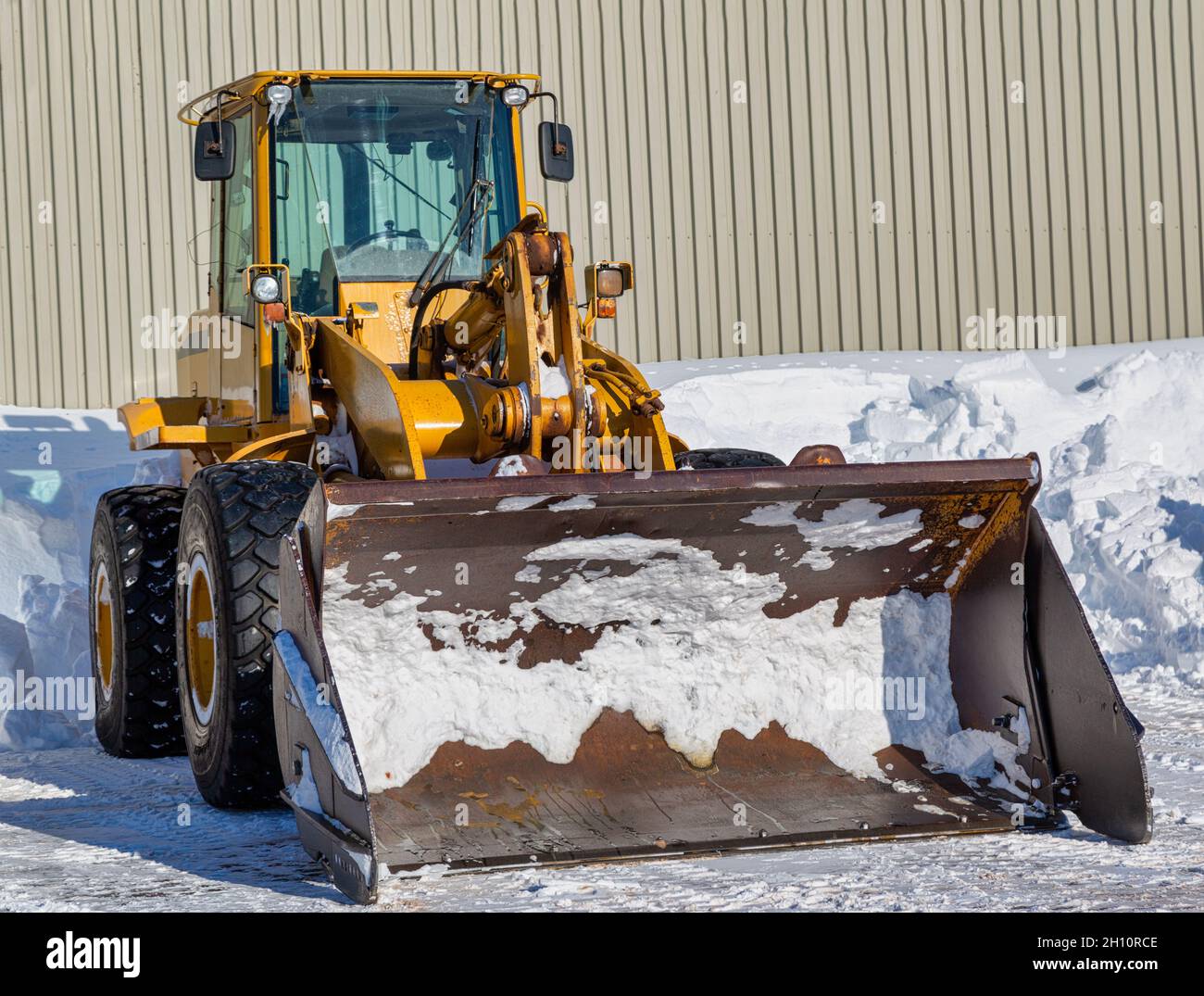 Large tractor with bucket used in snow removal Stock Photo - Alamy