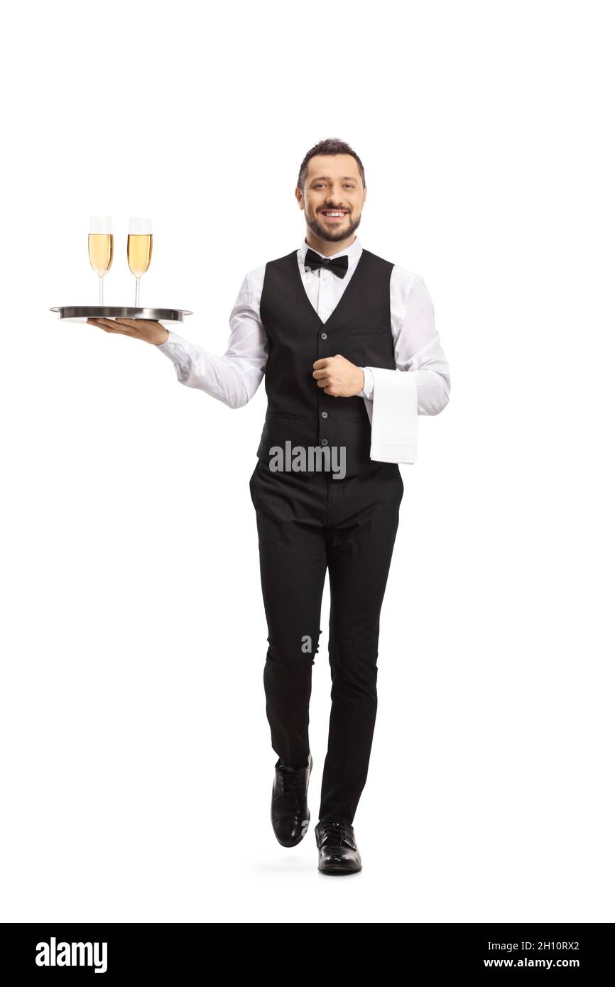 Full length portrait of a smiling waiter carrying a silver tray with ...