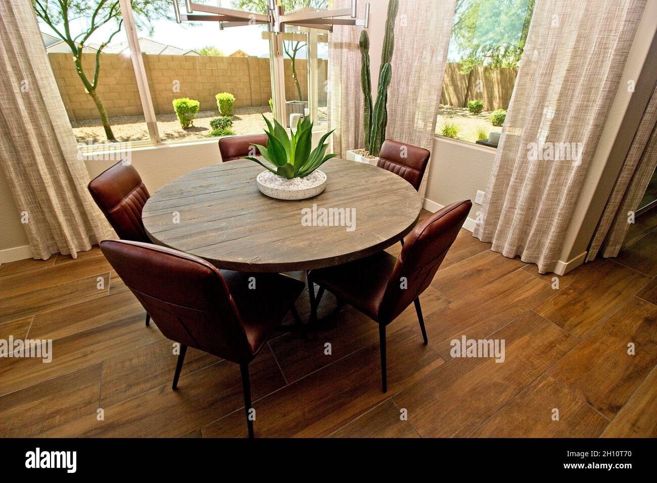 Round Wooden Table With Centerpiece In Kitchen Eating Area Stock Photo ...