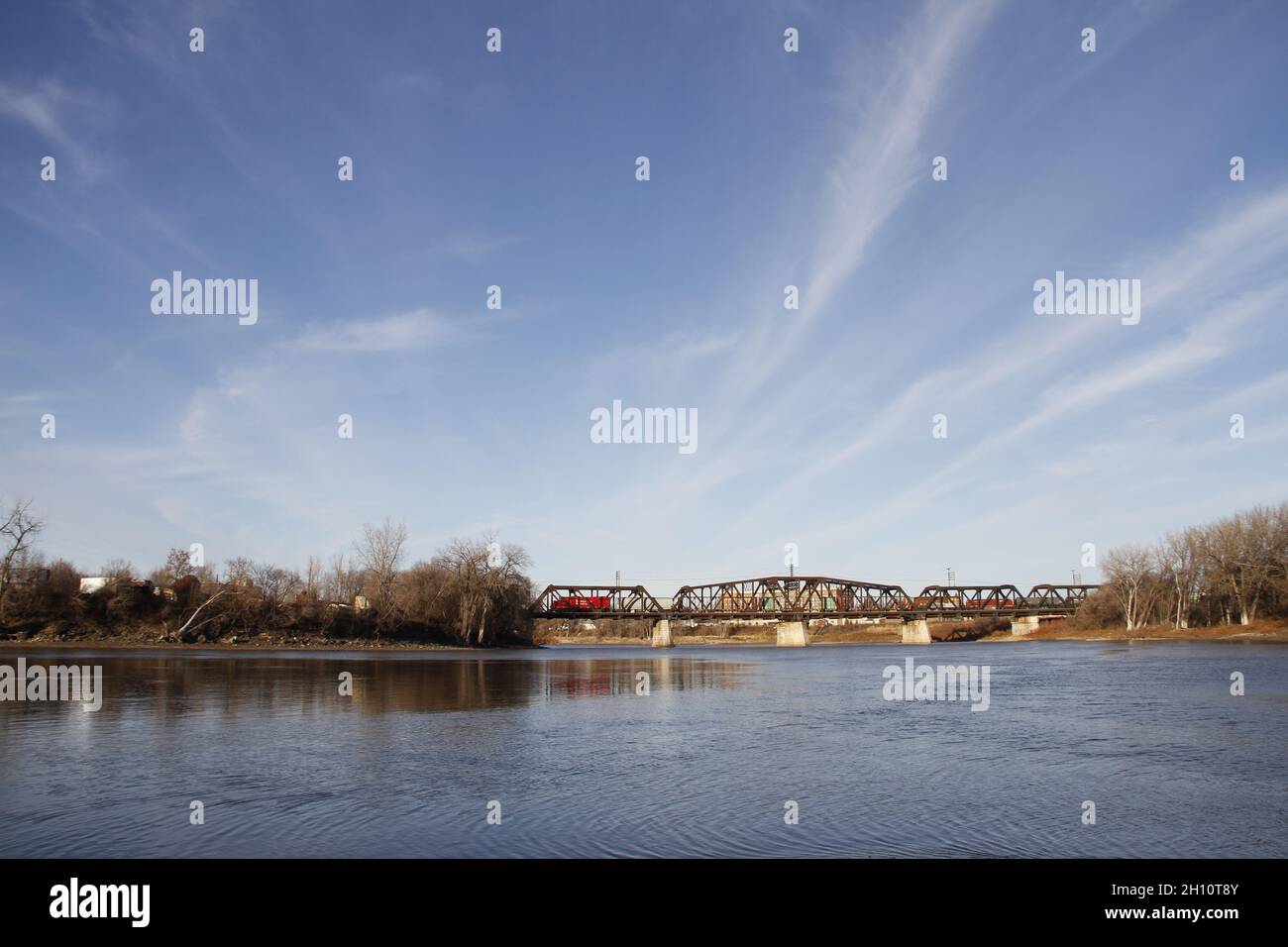 View of a train crossing a bridge over a body of water, Winnipeg ...