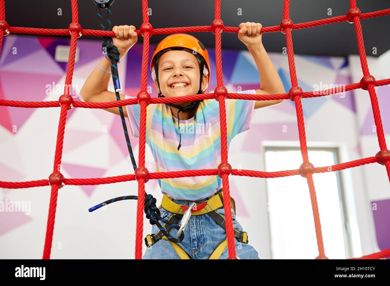 Little girl holding on to the ropes, zip line Stock Photo - Alamy