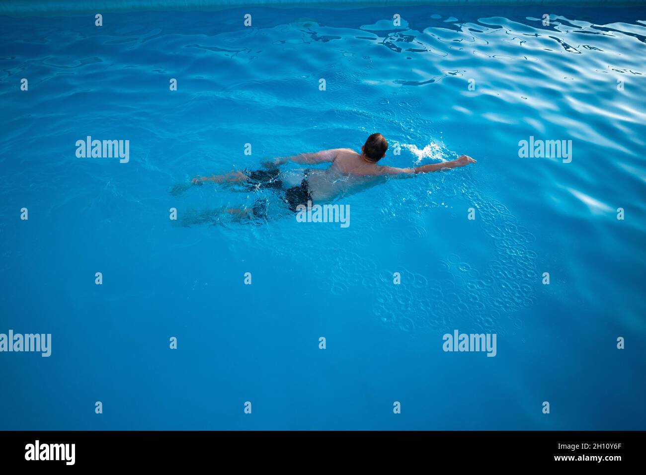 Spanish male swimming in a pool Stock Photo - Alamy