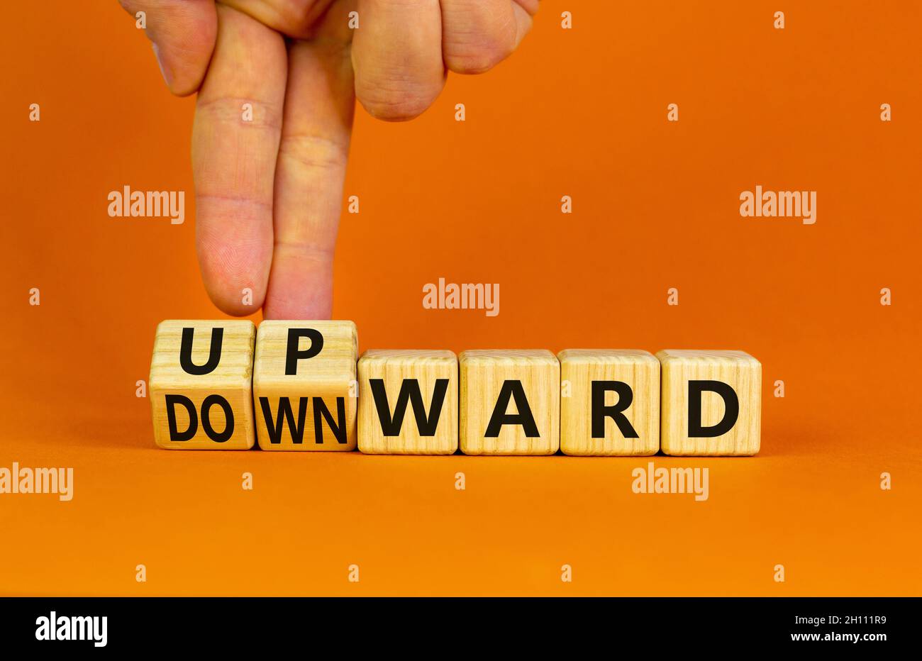 Upward or downward symbol. Businessman turns wooden cubes and changes ...