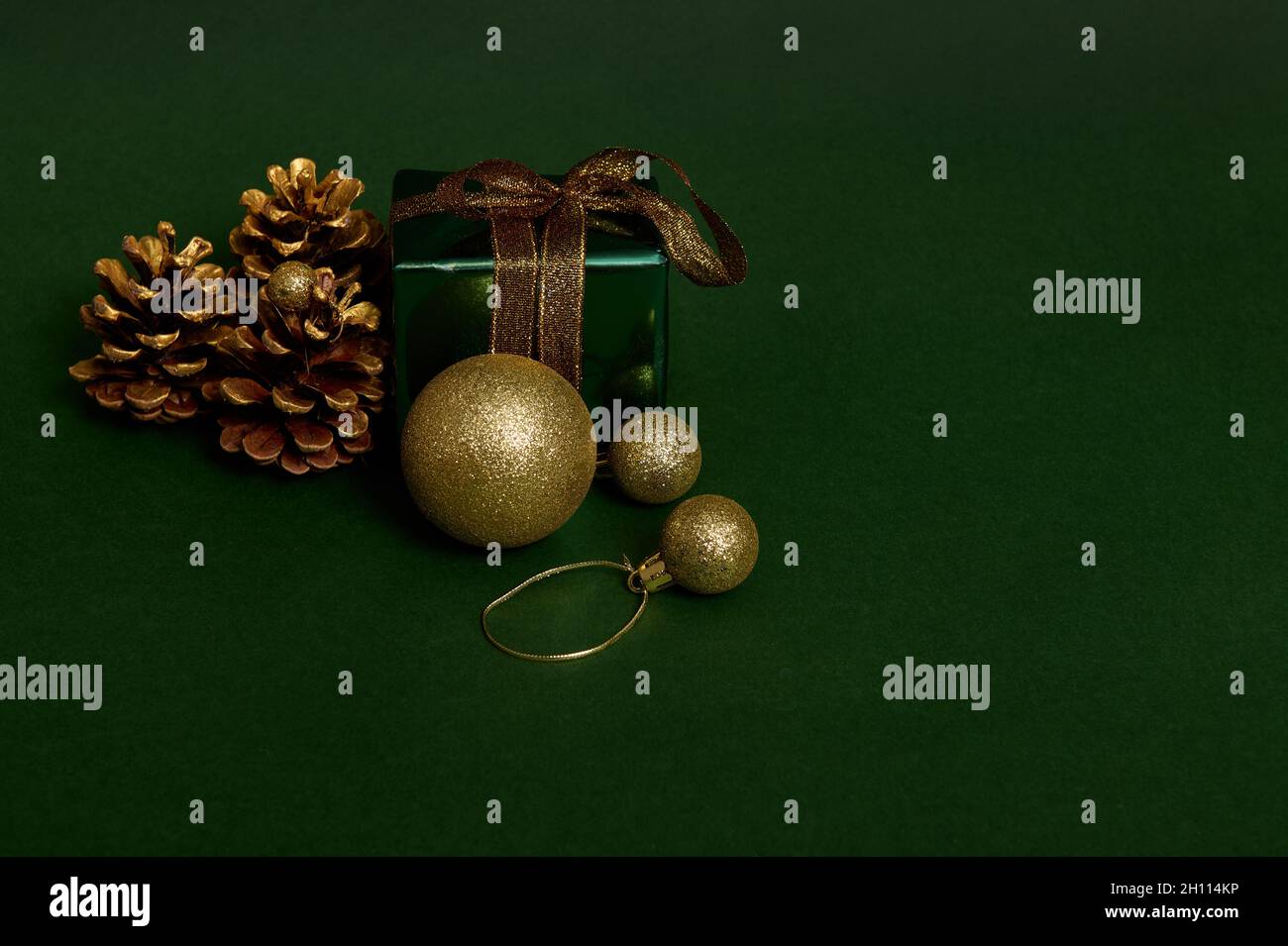 Front view of a present in shiny green glitter wrapping gift paper with ...