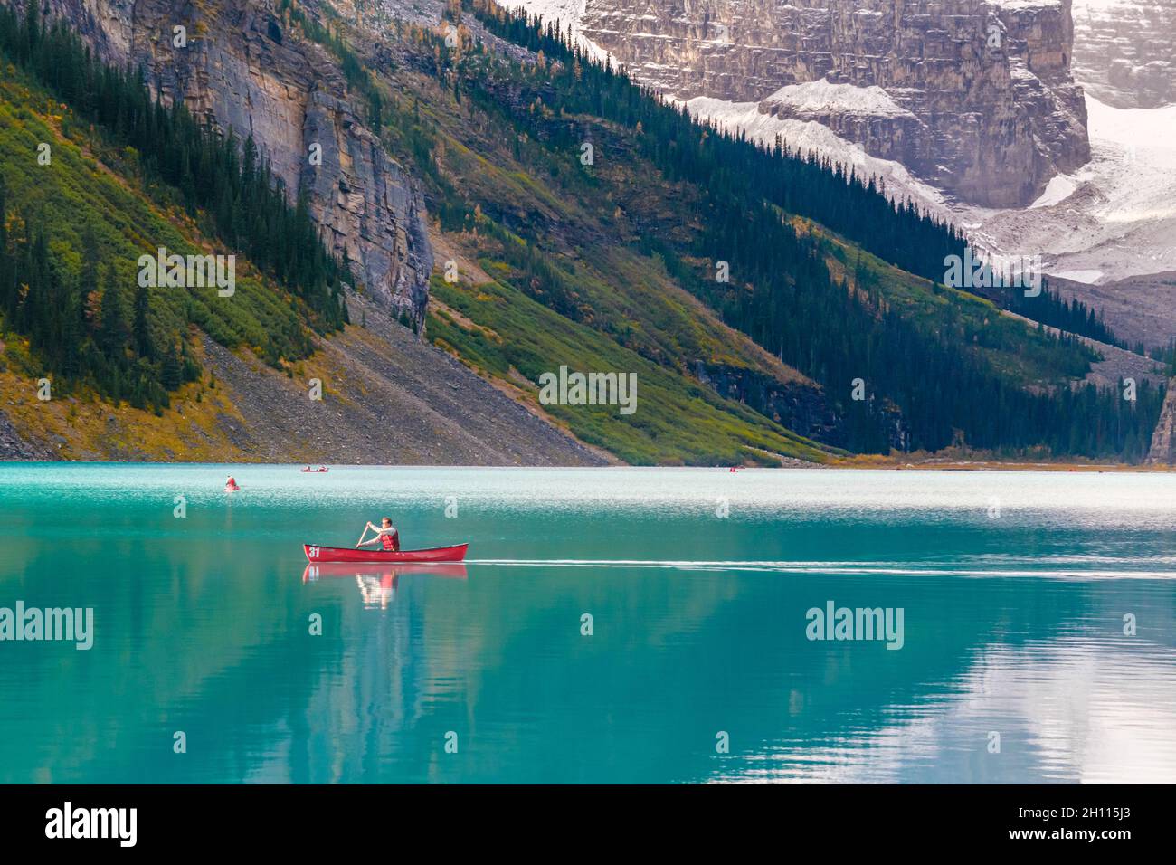 Lake Louise, Alberta, Canada - 29 September 2021: Man riding a Canoe on ...