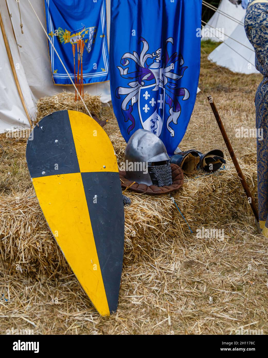 Vibrant red and yellow shield on dry grass in a camp tent Stock Photo ...