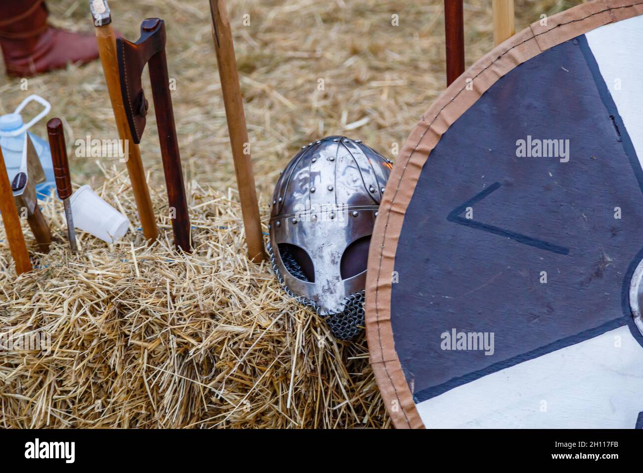 Medieval armor helmet behind a blue shield in the camp Stock Photo - Alamy