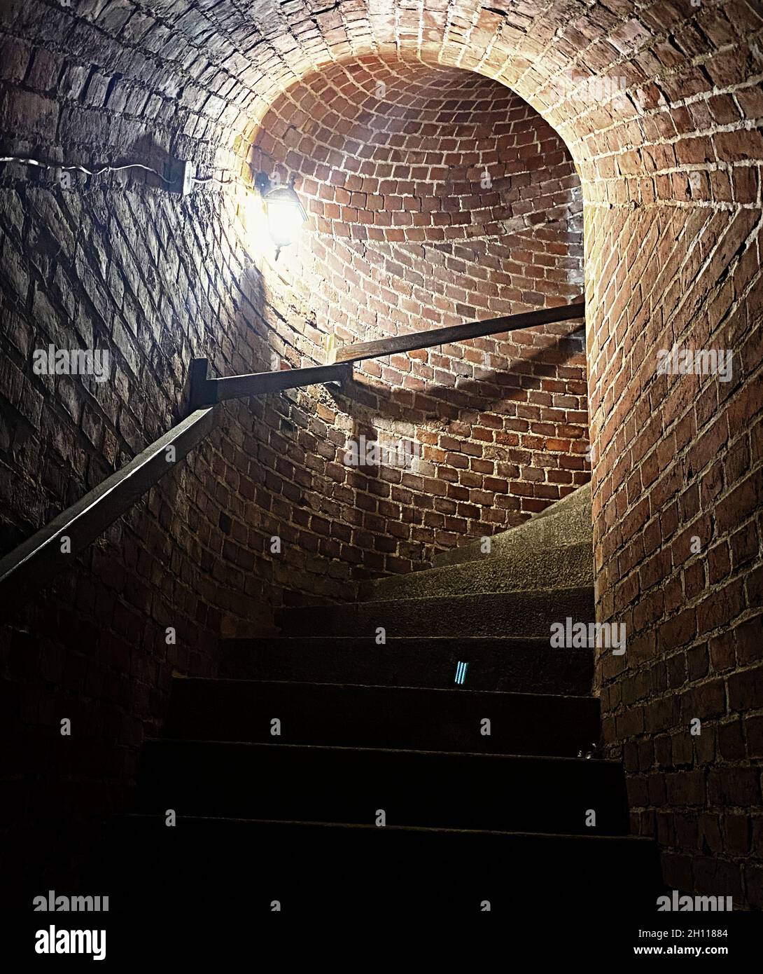 Eerie scenery of the stairs going up in an ancient tower of a castle ...