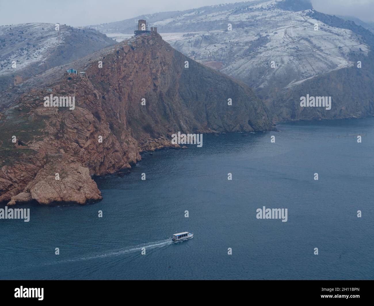 ancient castle ruins on a beautiful rock rise above the sea. winter ...