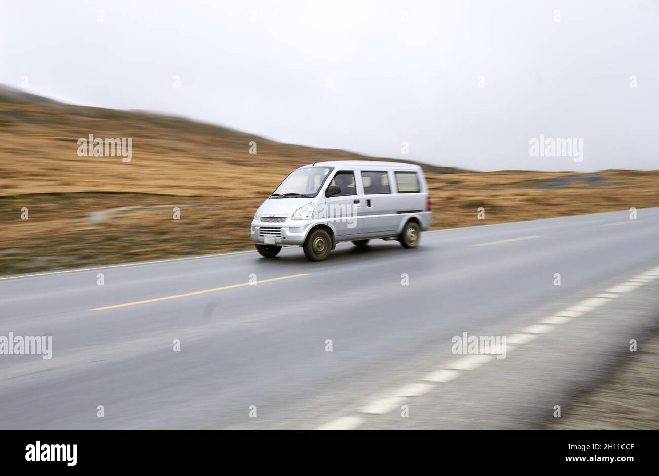 Side view of a minivan in a country line on a gloomy day Stock Photo ...