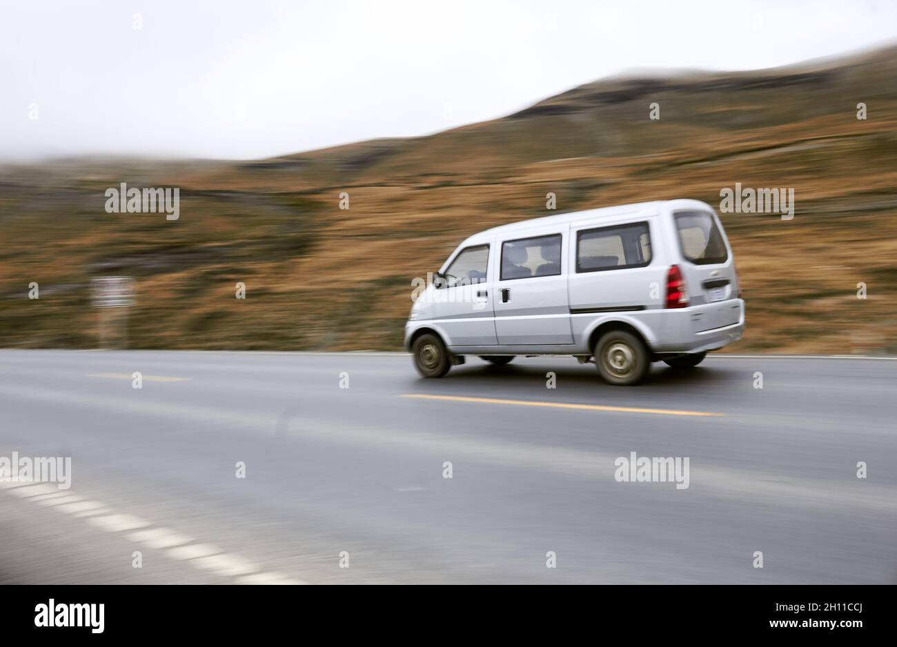 Side view of a minivan in a country line on a gloomy day Stock Photo ...