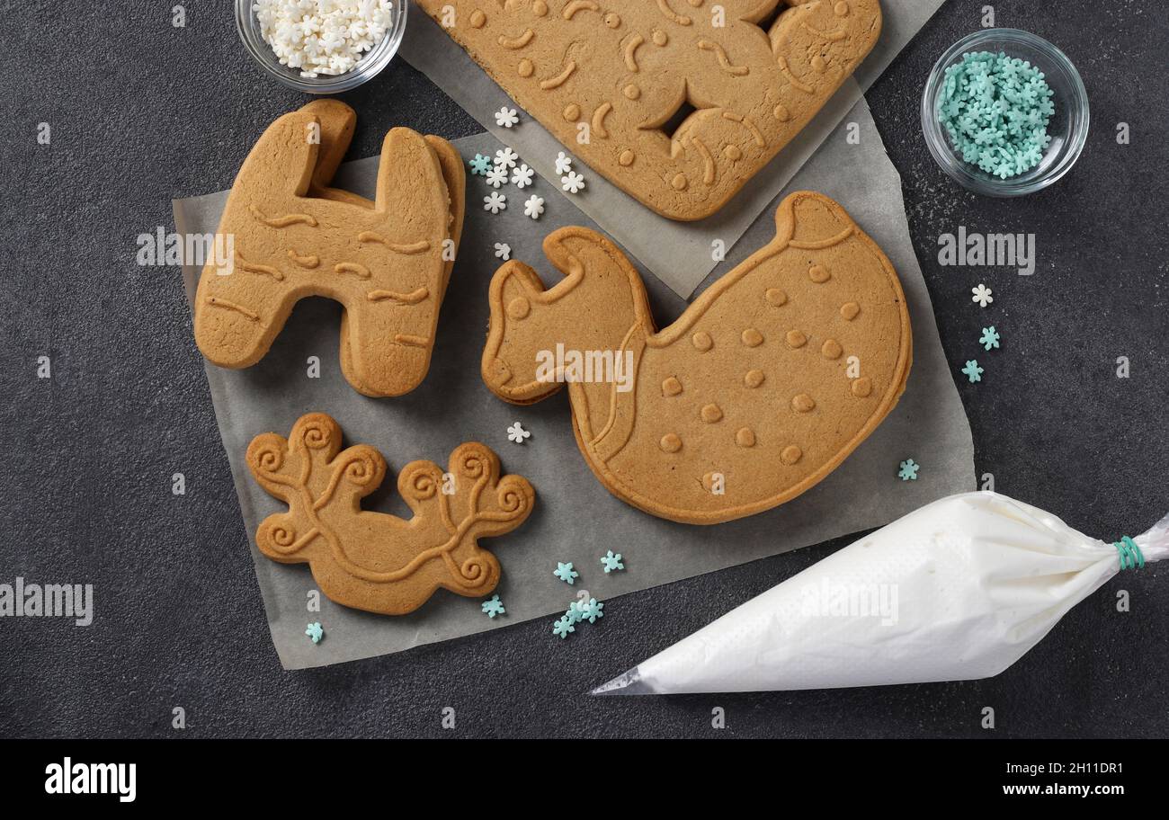 Build deer-shaped gingerbread at home. Step by step. Top view on gray ...