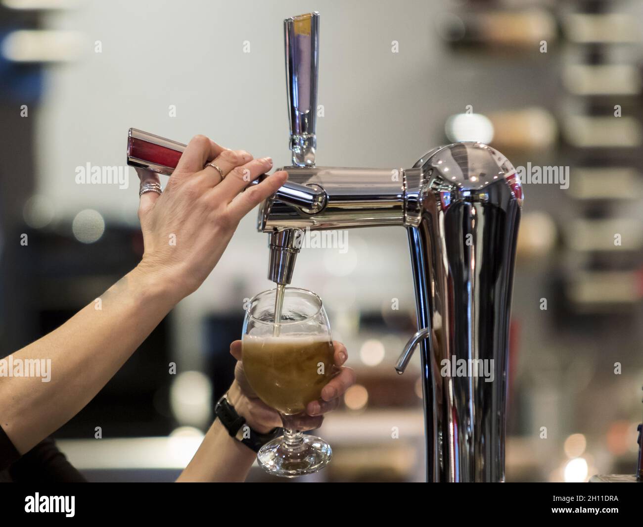 Bartender pouring a refreshing beer from the tap to the glass Stock ...