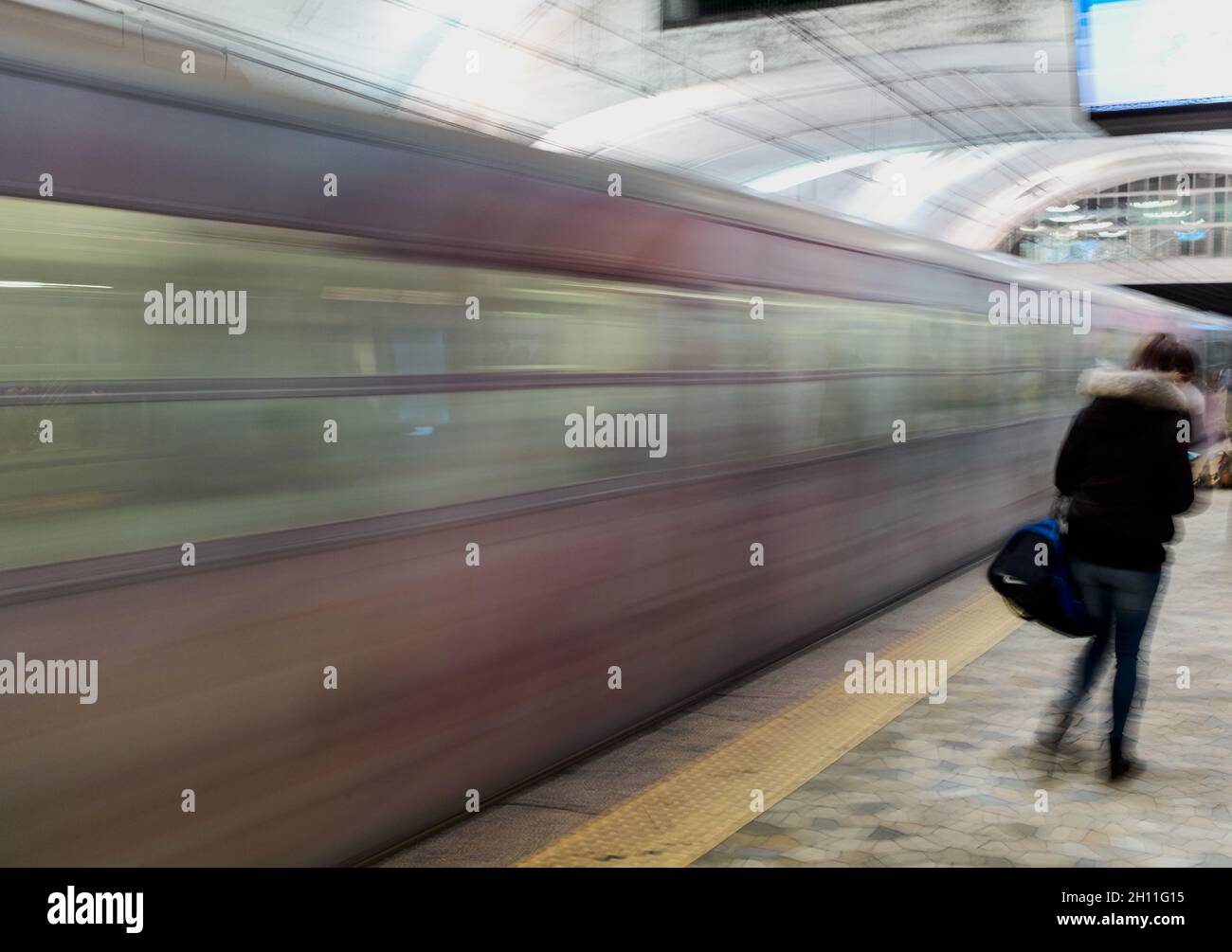 Moving subway and a female standing on the train platform - transport ...