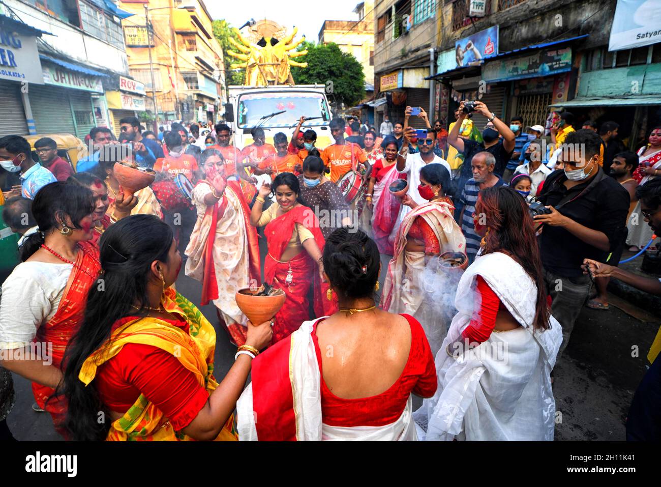 Hindu women seen dancing with an idol of Devi Durga during the Vijaya ...