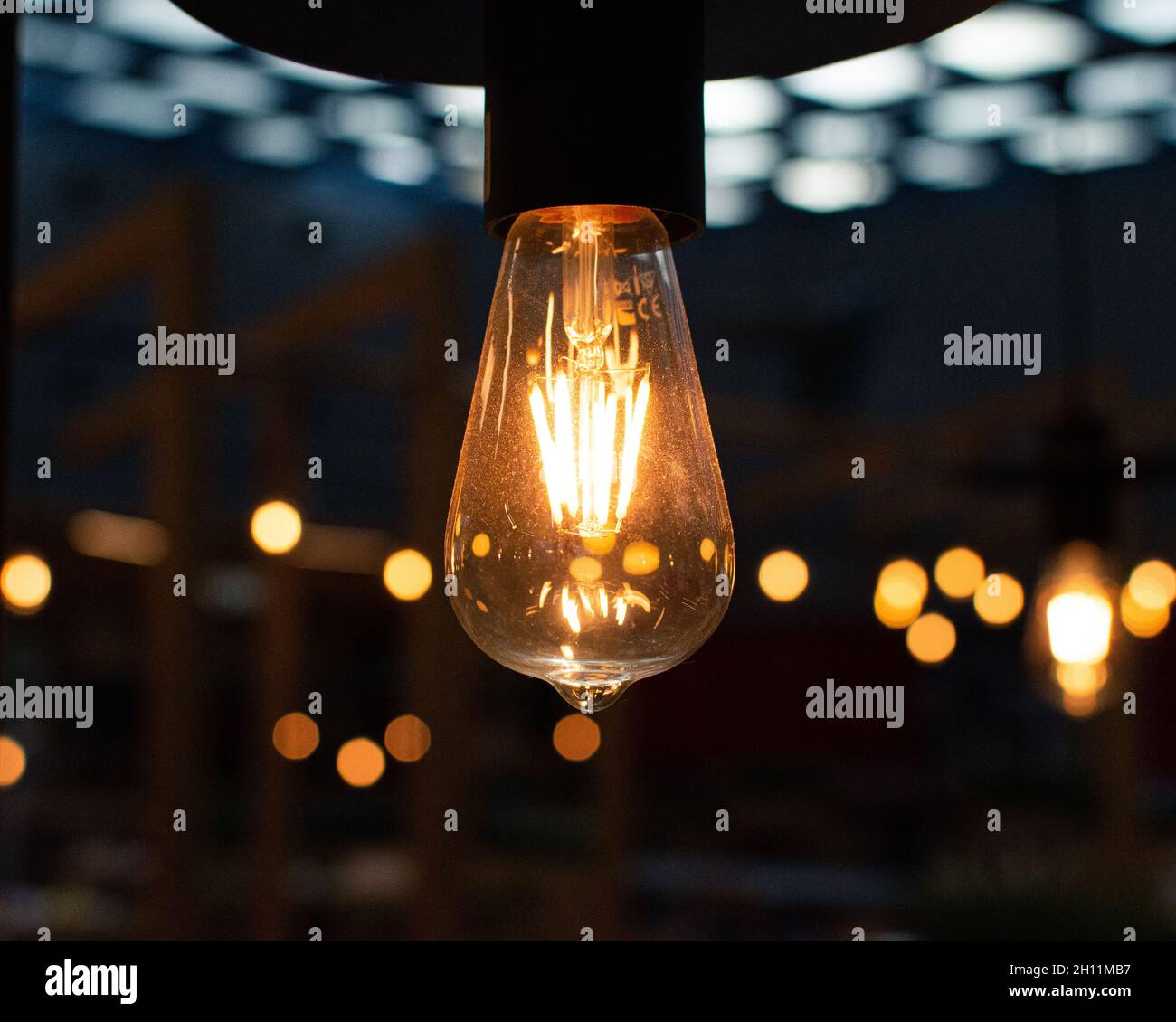 Decorative light bulb hanging in a cafe Stock Photo - Alamy