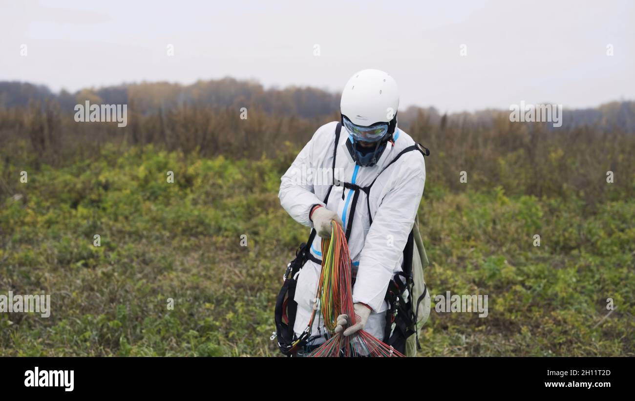 Man carries parachute. Action. Man carries multi-colored parachute ...