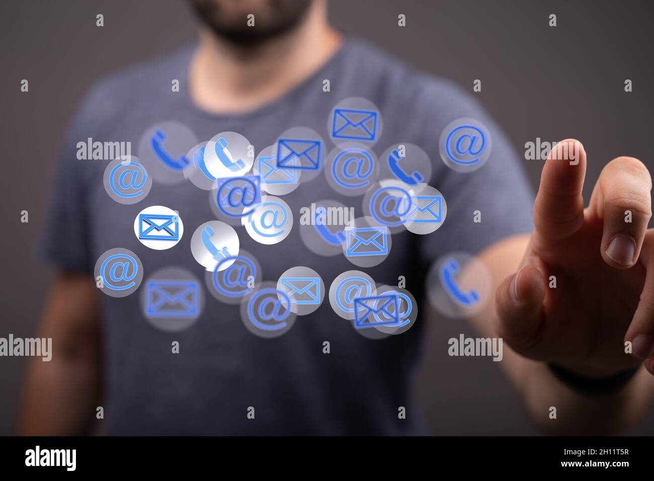 Human hand showing network communications with email and phone symbols ...
