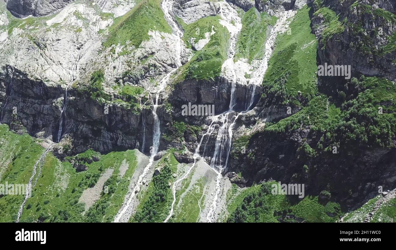Waterfall flowing down from high mountains on a Sunny day. Top view of ...