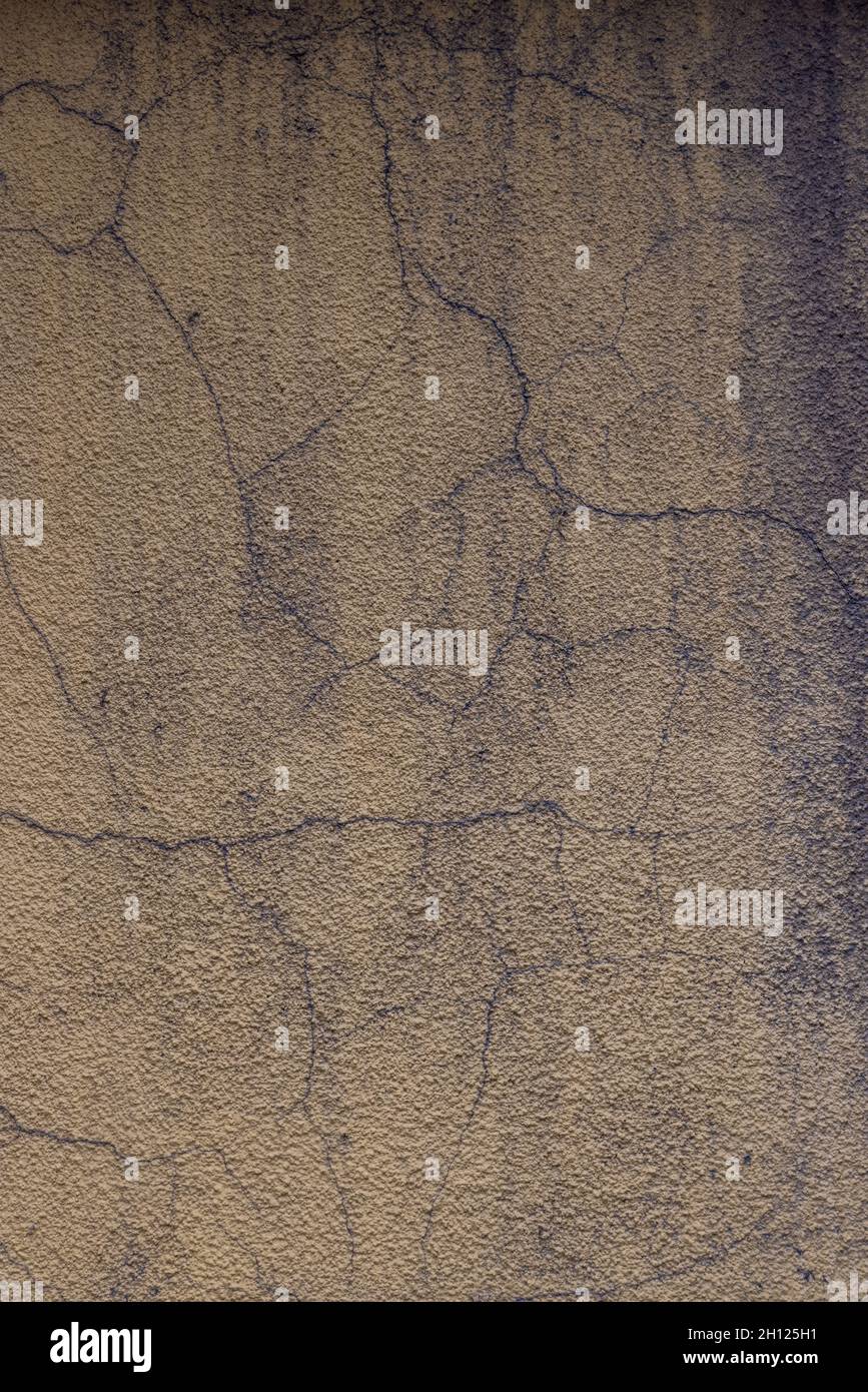 cracked dusty yellow rough plaster wall with gray smudges Stock Photo ...