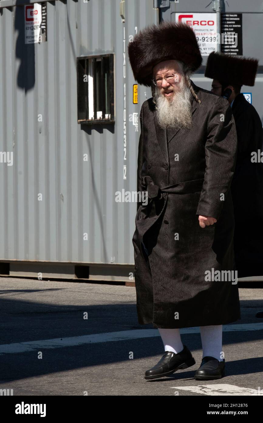 An orthodox Jewish man wearing his holiday clothes on Sukkkot. On Lee ...