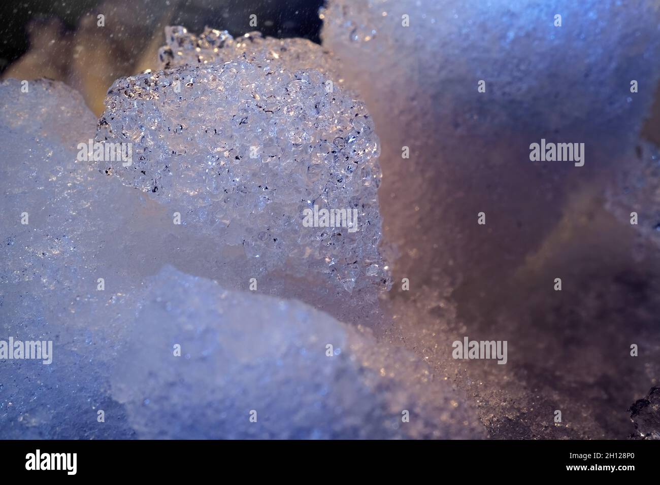Melting snow. Close-up of ice crystals turning into water. Structure of ...