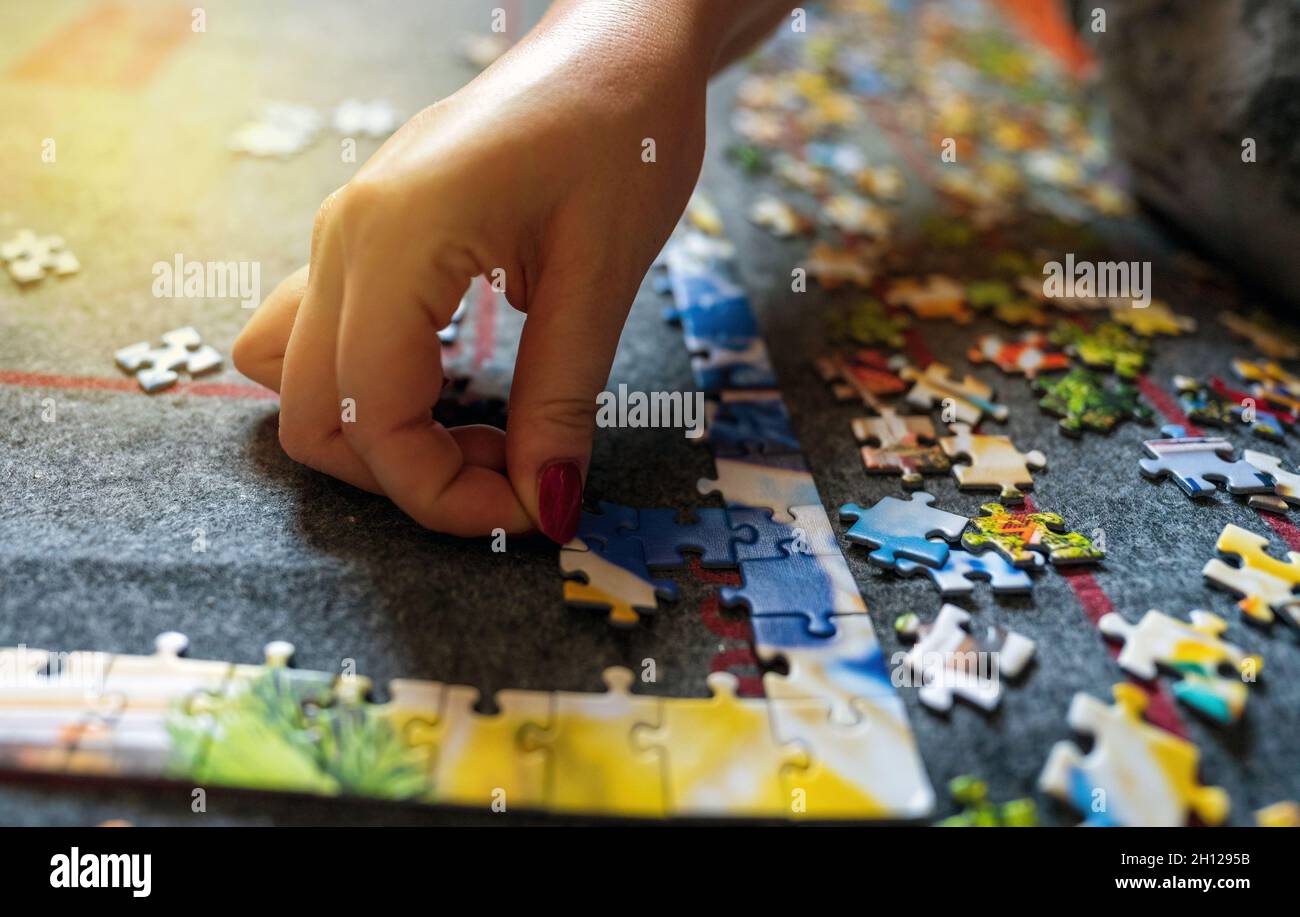 Jigsaw piece of puzzle assembling. Final stage of project. Complex ...