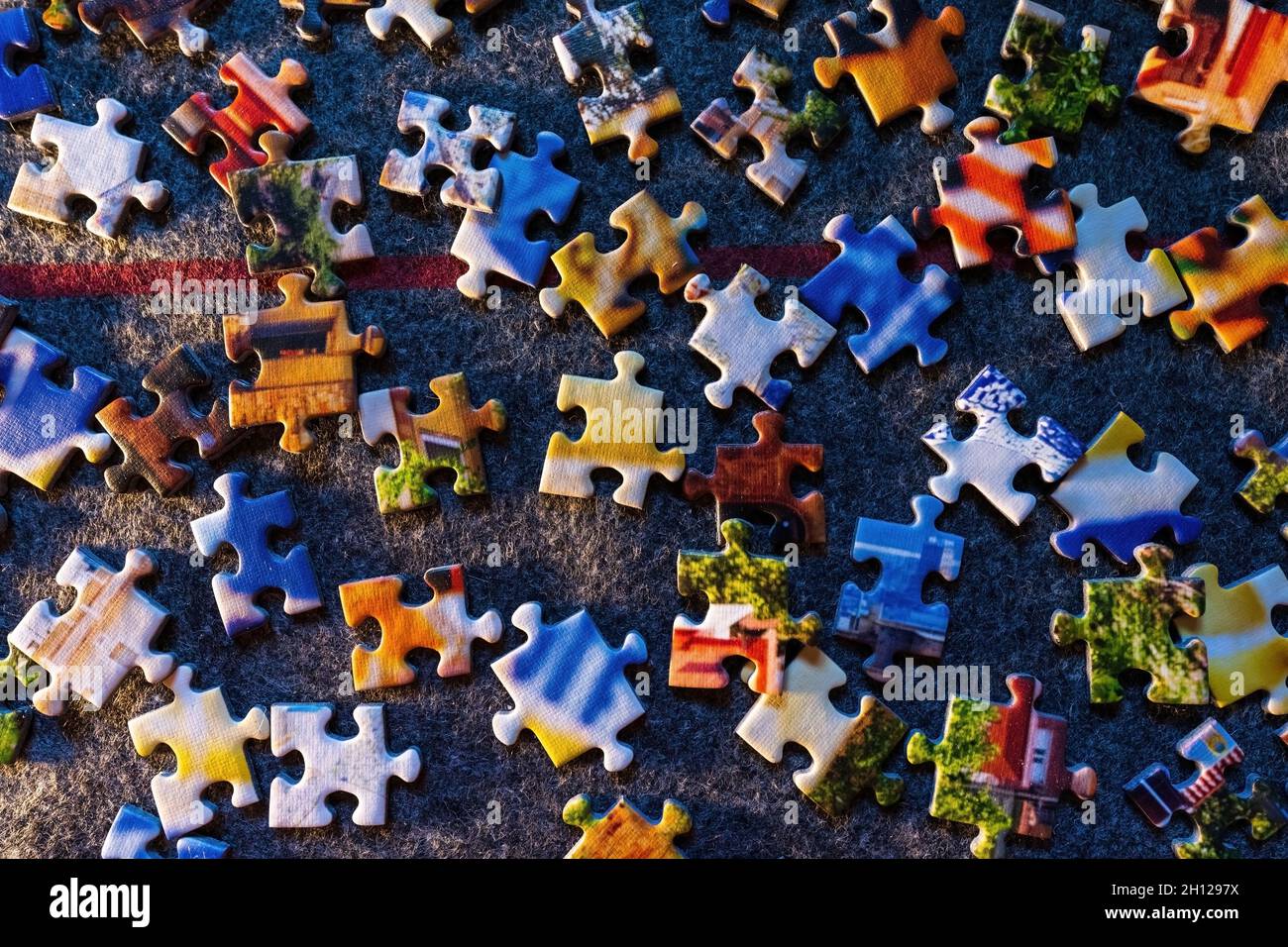 Colorful puzzle flat lay separated pieces kept on floor, indoor games ...