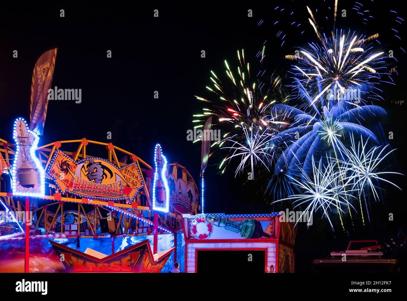Germany, 10-16-2021: Funfair at night with fireworks in background ...
