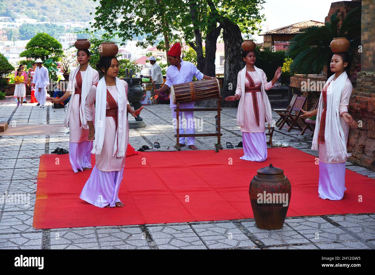 Young Vietnamese women in beautiful costumes perform a traditional ...