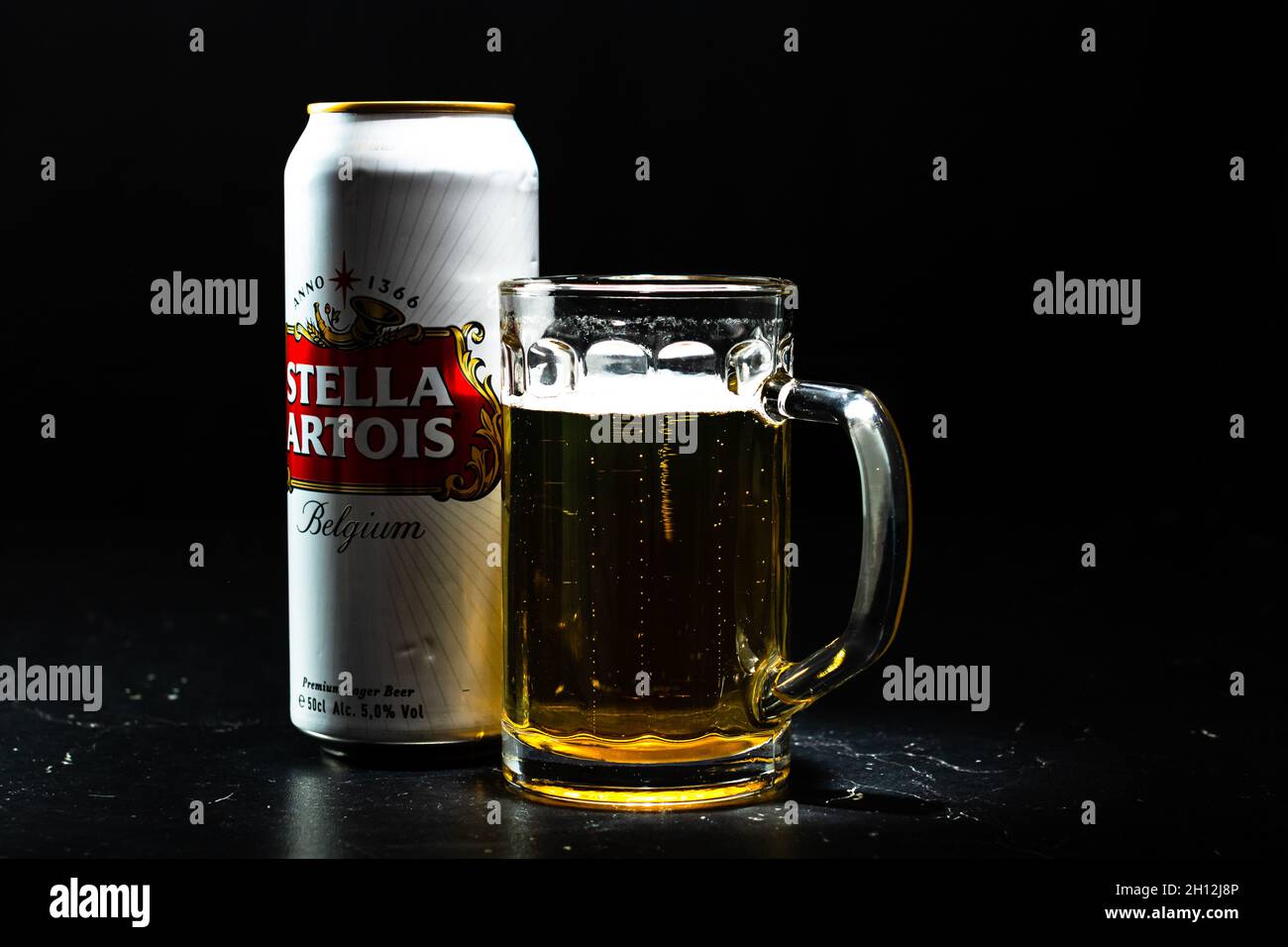 Can of Stella Artois beer and beer glass on dark background ...